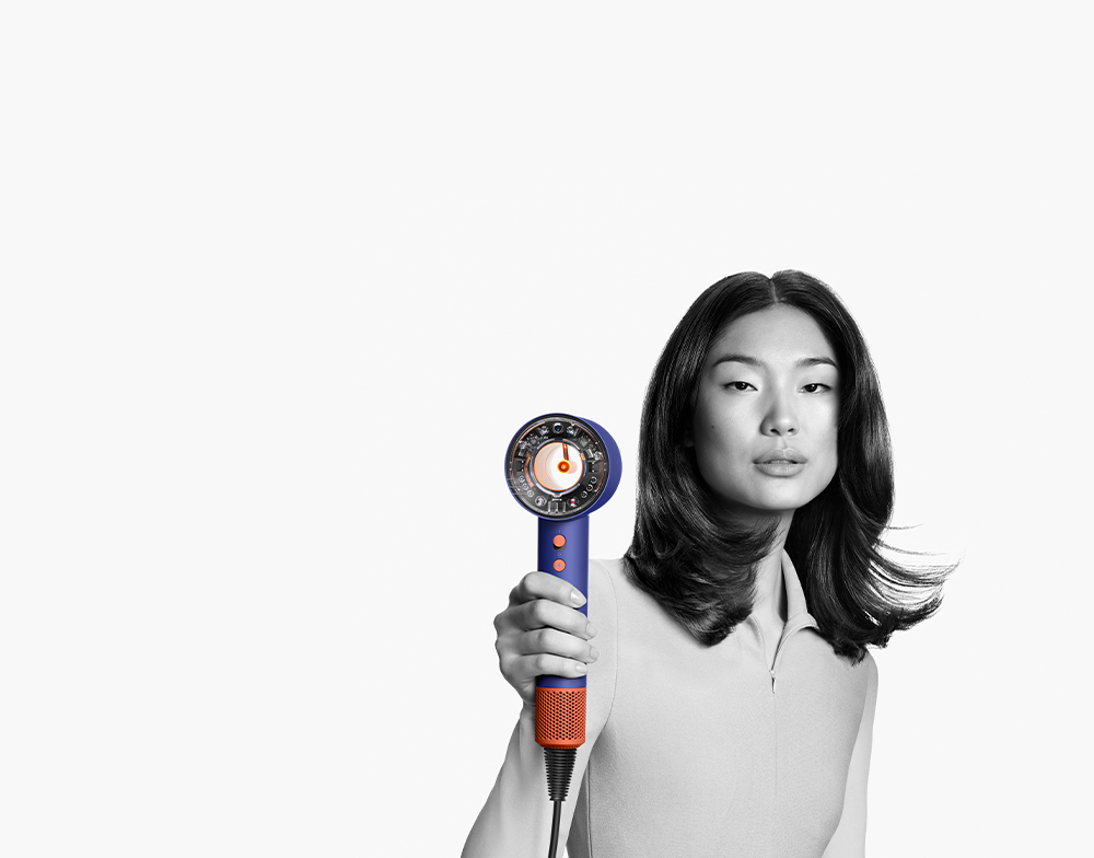 Woman using the Dyson Supersonic Nural hair dryer
